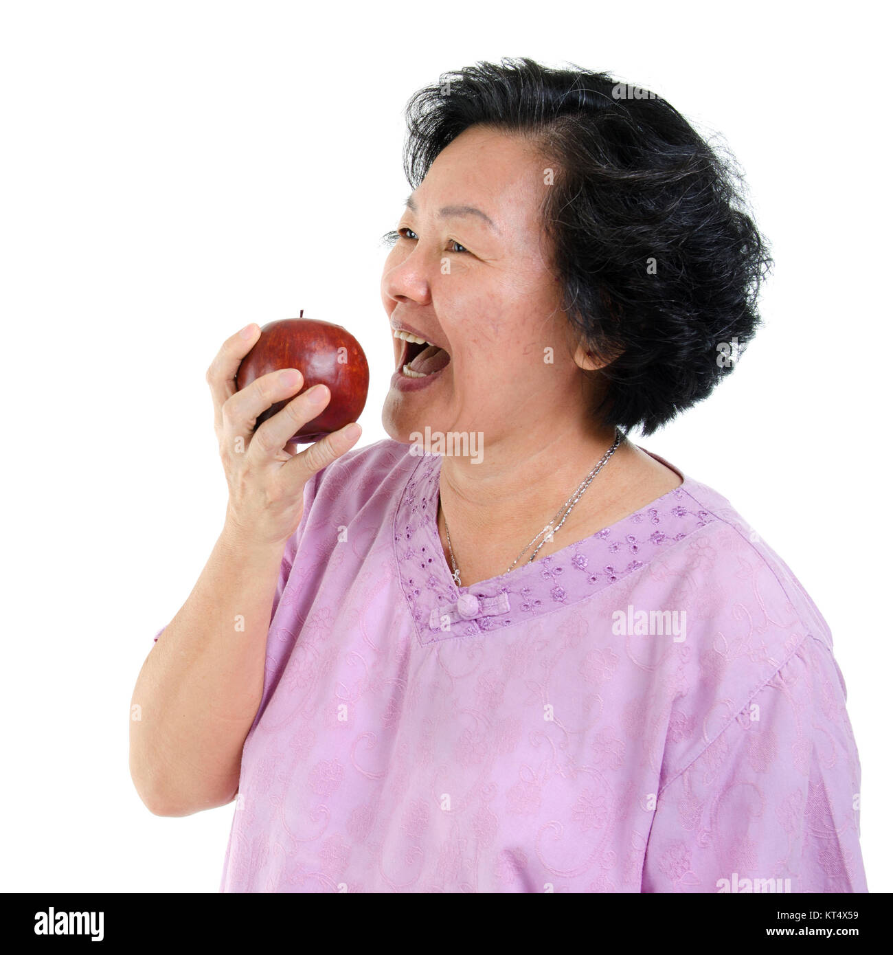Senior adult woman eating apple Stock Photo - Alamy