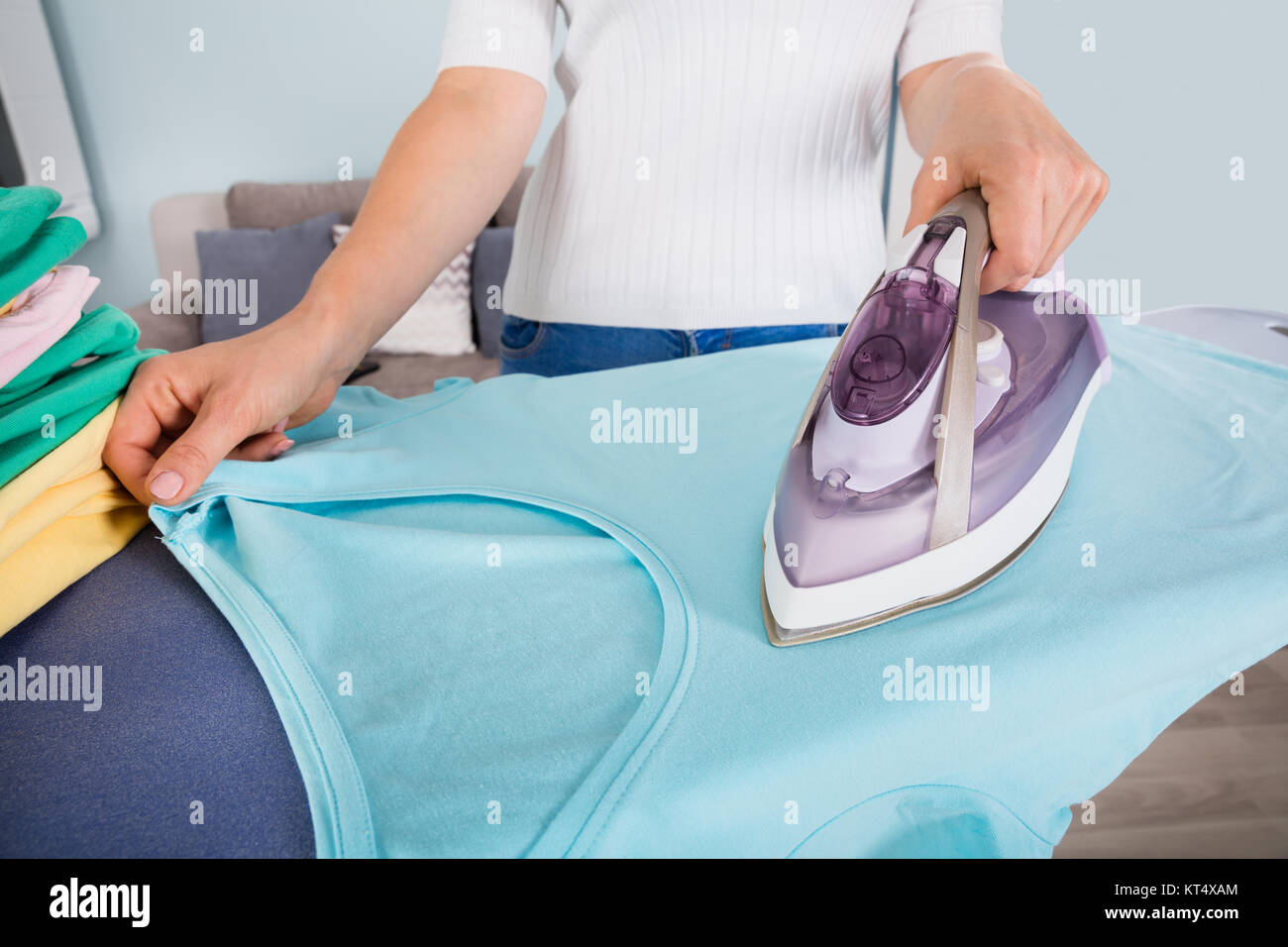 Maid Ironing Clothes On Ironing Board Stock Photo - Alamy