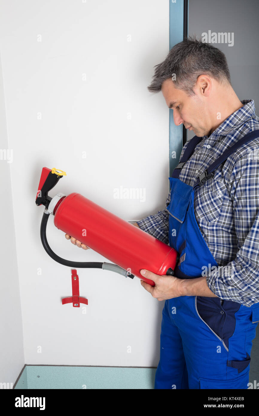 Professional Checking A Fire Extinguisher Stock Photo - Alamy