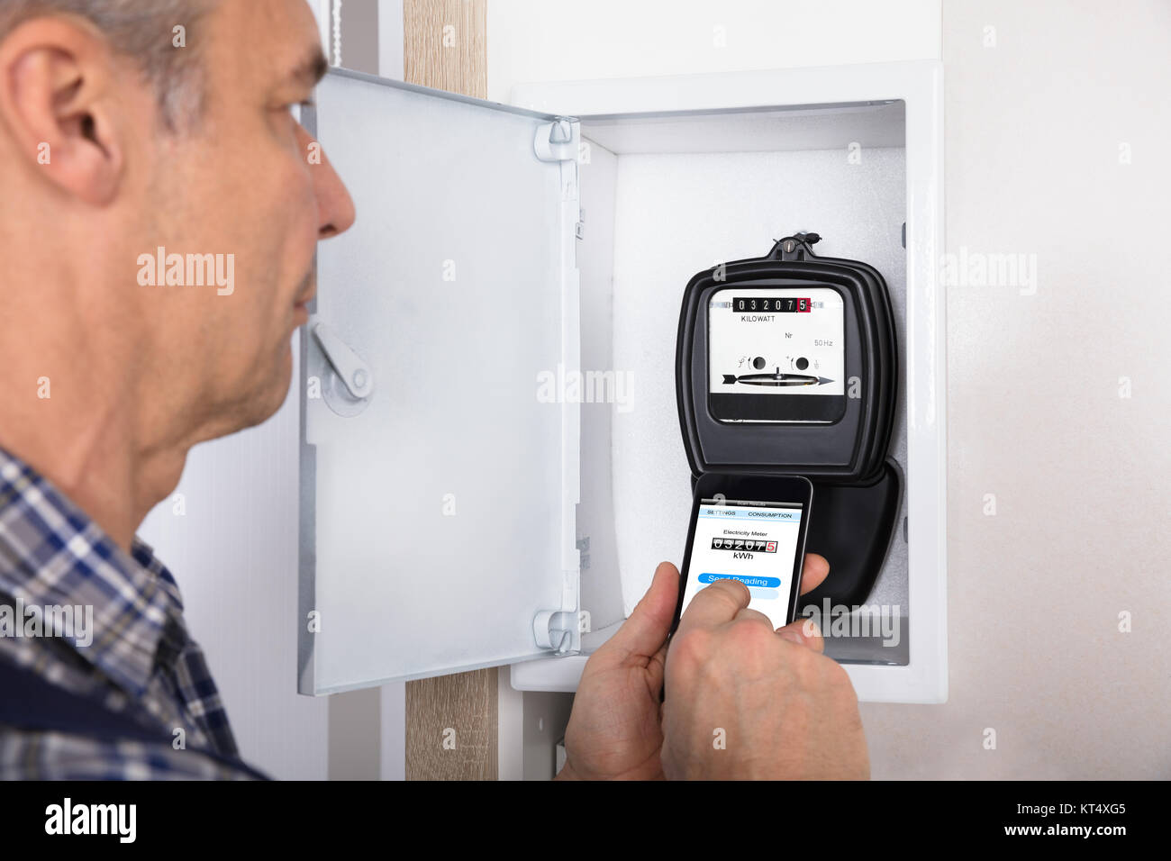 Technician Doing Meter Reading Using Mobilephone Stock Photo - Alamy
