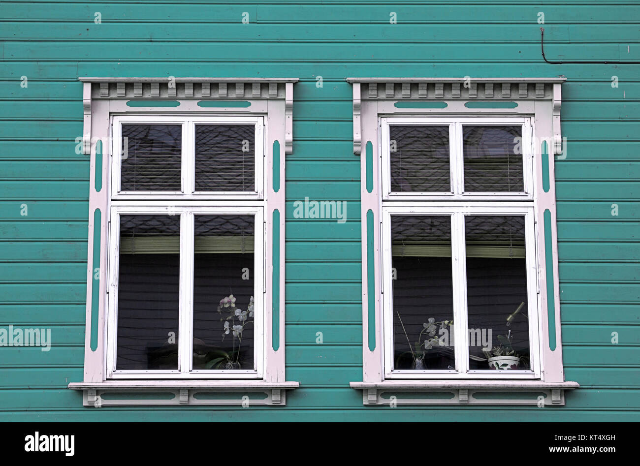 cyan house two white windows Stock Photo - Alamy