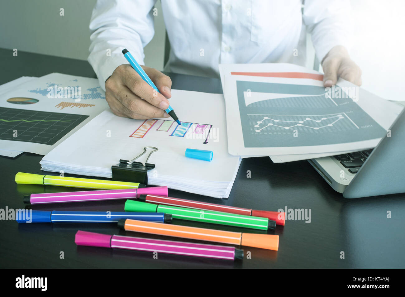 Man writing graph on paper with color pen Stock Photo - Alamy