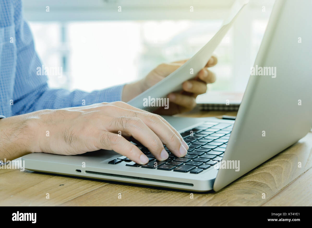 Close-up man hand using computer laptop and finance document Stock ...