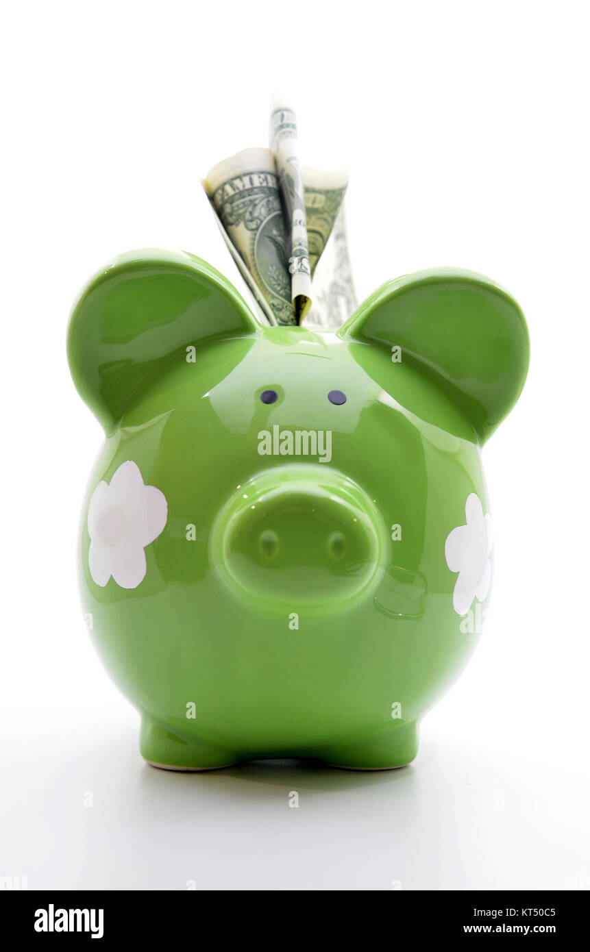 Green piggy bank with US dollar bills Stock Photo - Alamy