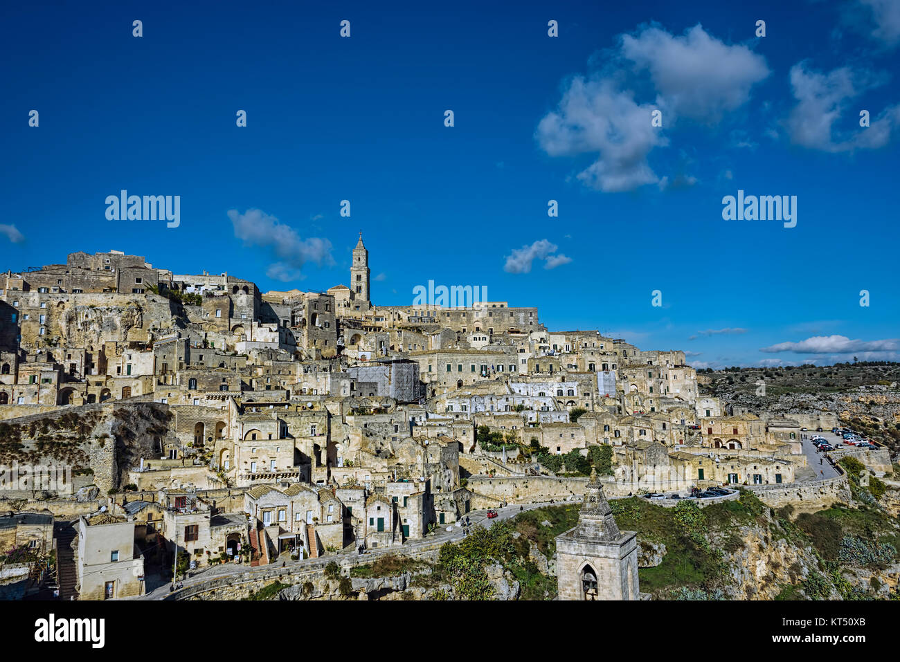 A city on a rocky outcrop and a complex of cave dwellings carved into ...
