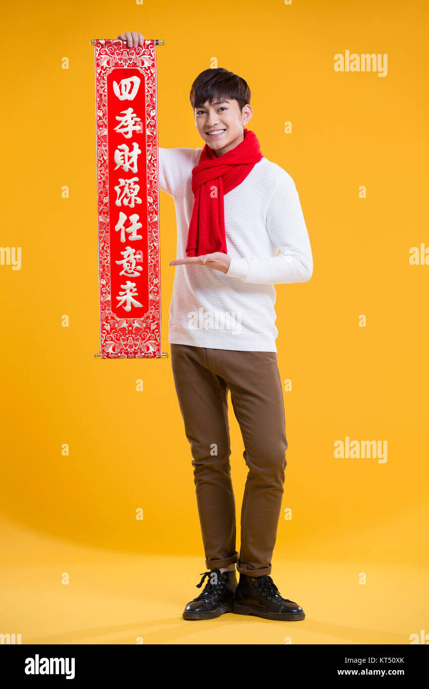 Cheerful young man celebrating Chinese New Year with couplet Stock ...