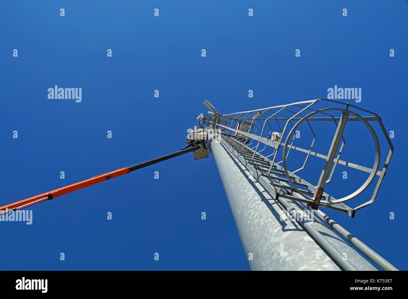 Hydraulic mobile construction platform elevated towards a blue sky with ...