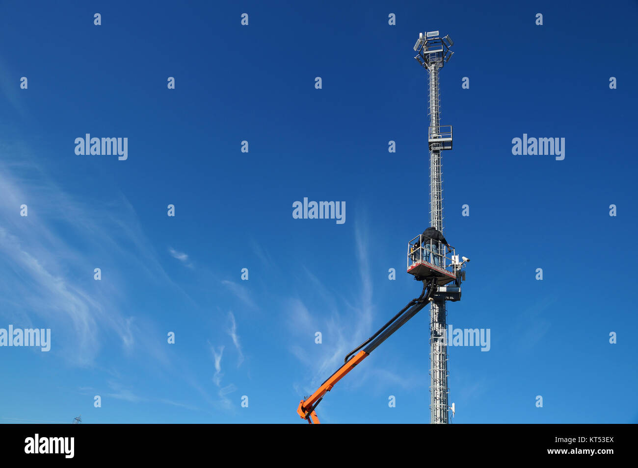 Hydraulic mobile construction platform elevated towards a blue sky with ...