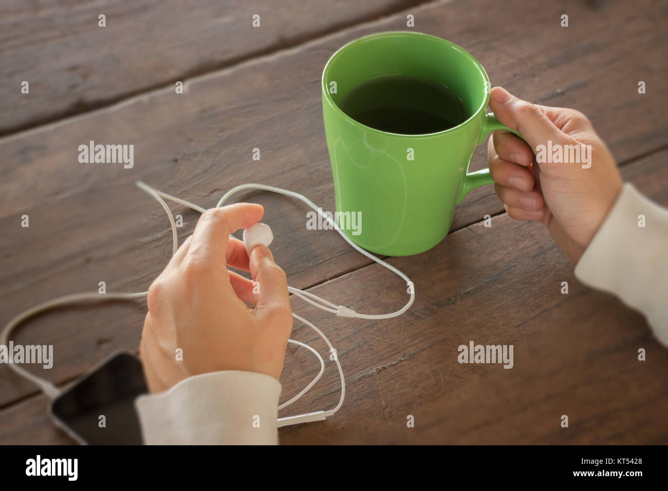Woman hand on hot green tea drinking Stock Photo - Alamy