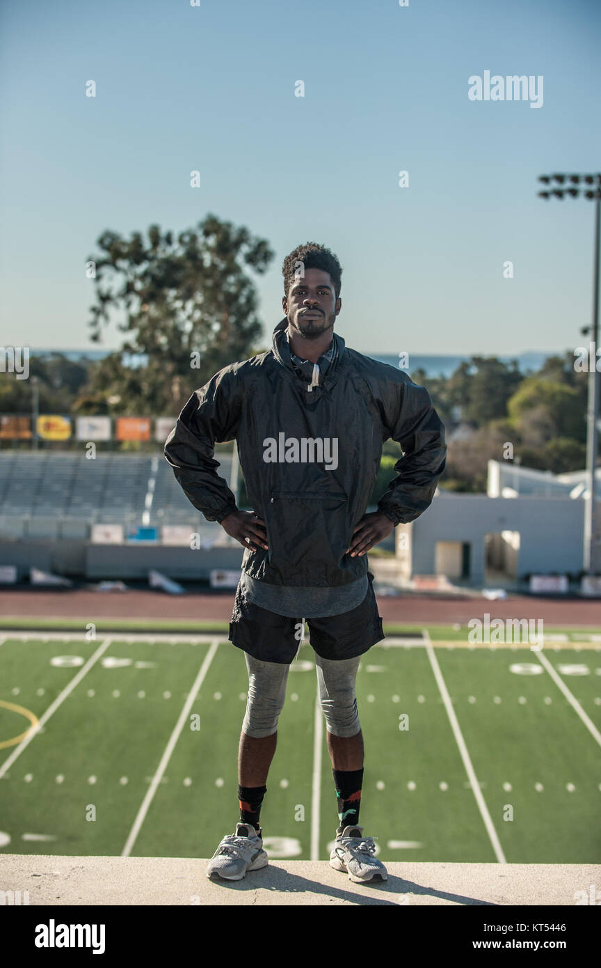 Lean Jamaican athlete feeling heroic over field at stadium in confident ...