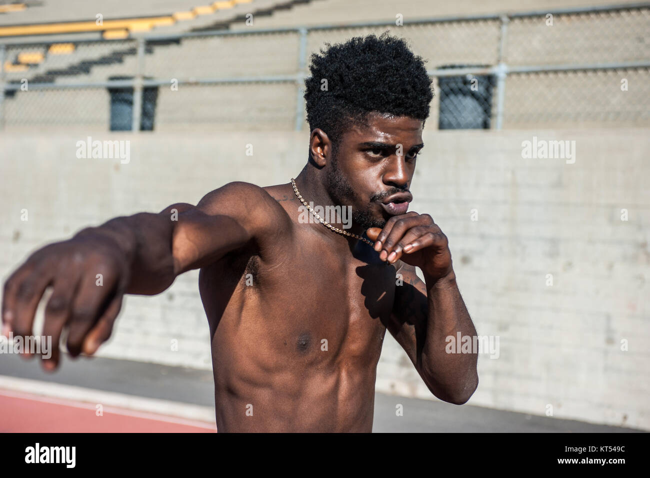 Muscular Jamaican boxer throwing right punch while shadowboxing on ...