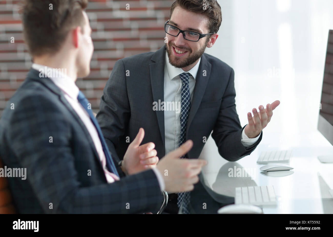 Manager talking with a colleague Stock Photo - Alamy