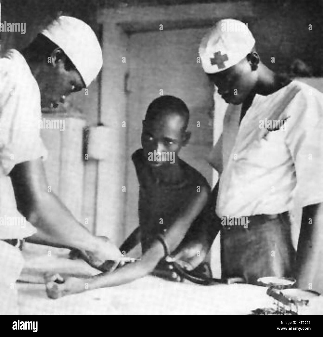 This photograph depicts native workers serving as medical assistants in ...
