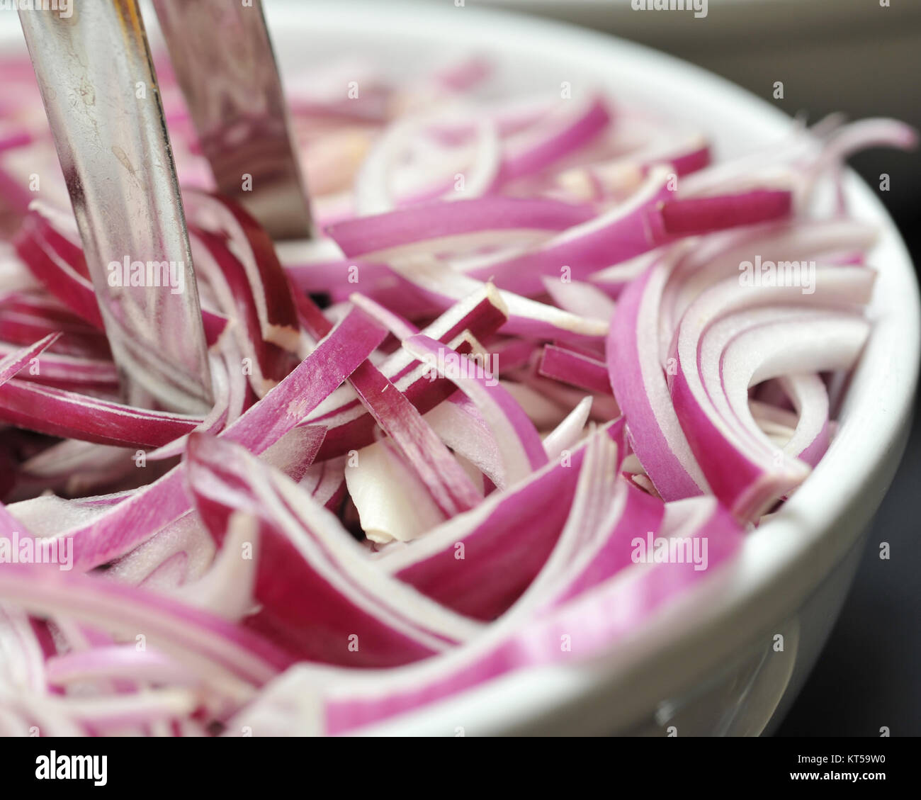 Sliced red onion in a bowl Stock Photo - Alamy
