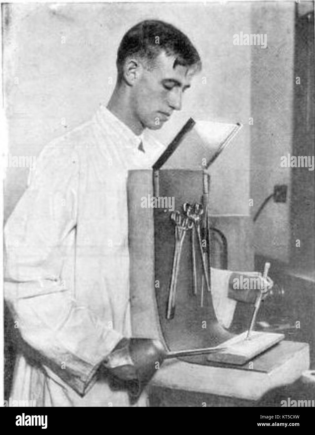 A radium worker from 1929 uses a lead shield for safety while handling ...