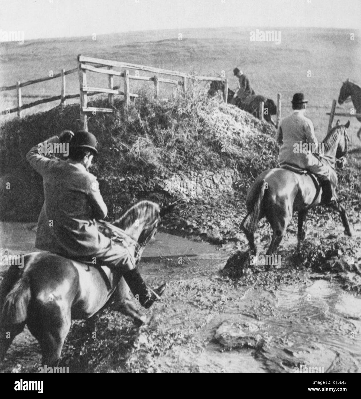 This image depicts riders on horseback as they wade through water ...