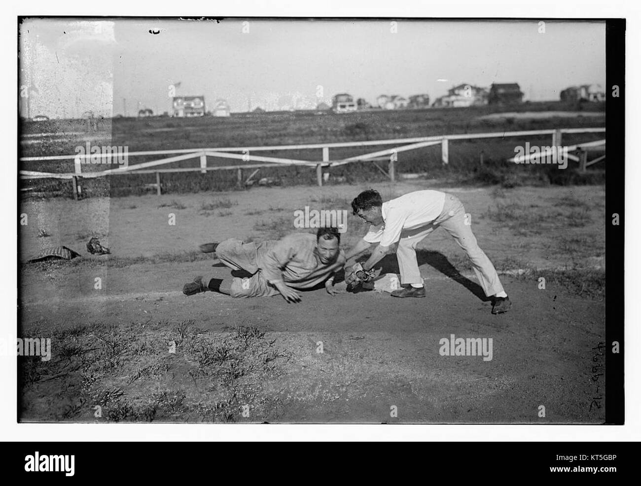 This image captures a moment in a sandlot baseball game, a casual form ...
