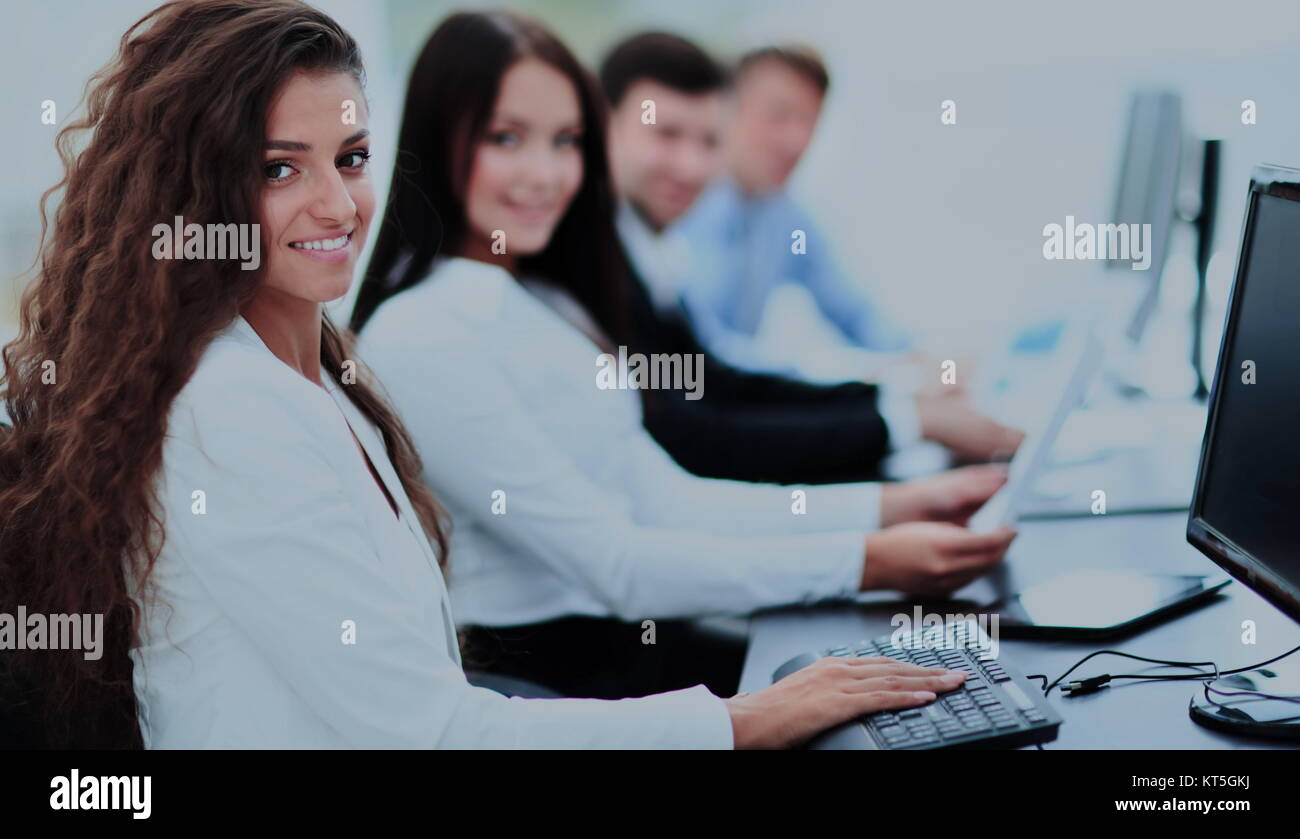 Happy young businesswoman looking behind and her colleagues work Stock ...