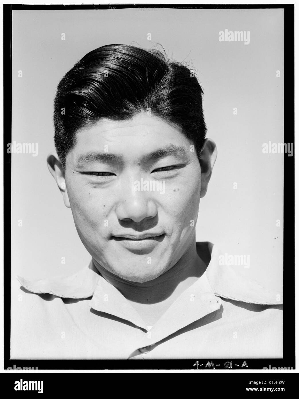 Photograph by Ansel Adams showing Henry Hanawa, a mechanic at the ...