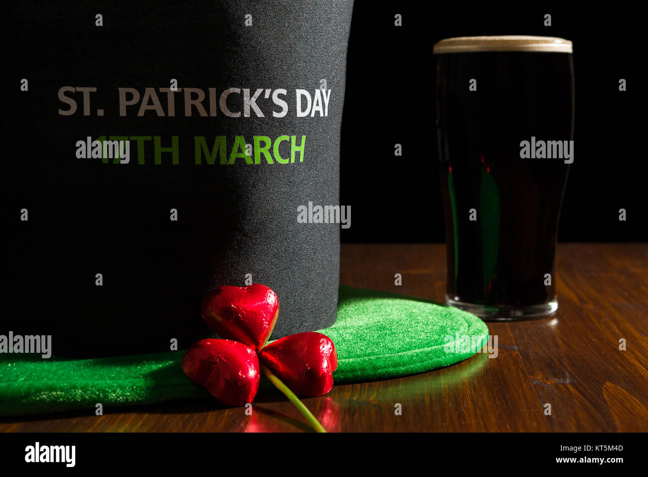 Closeup of St Patrick day with a pint of black beer, hat and shamrock ...
