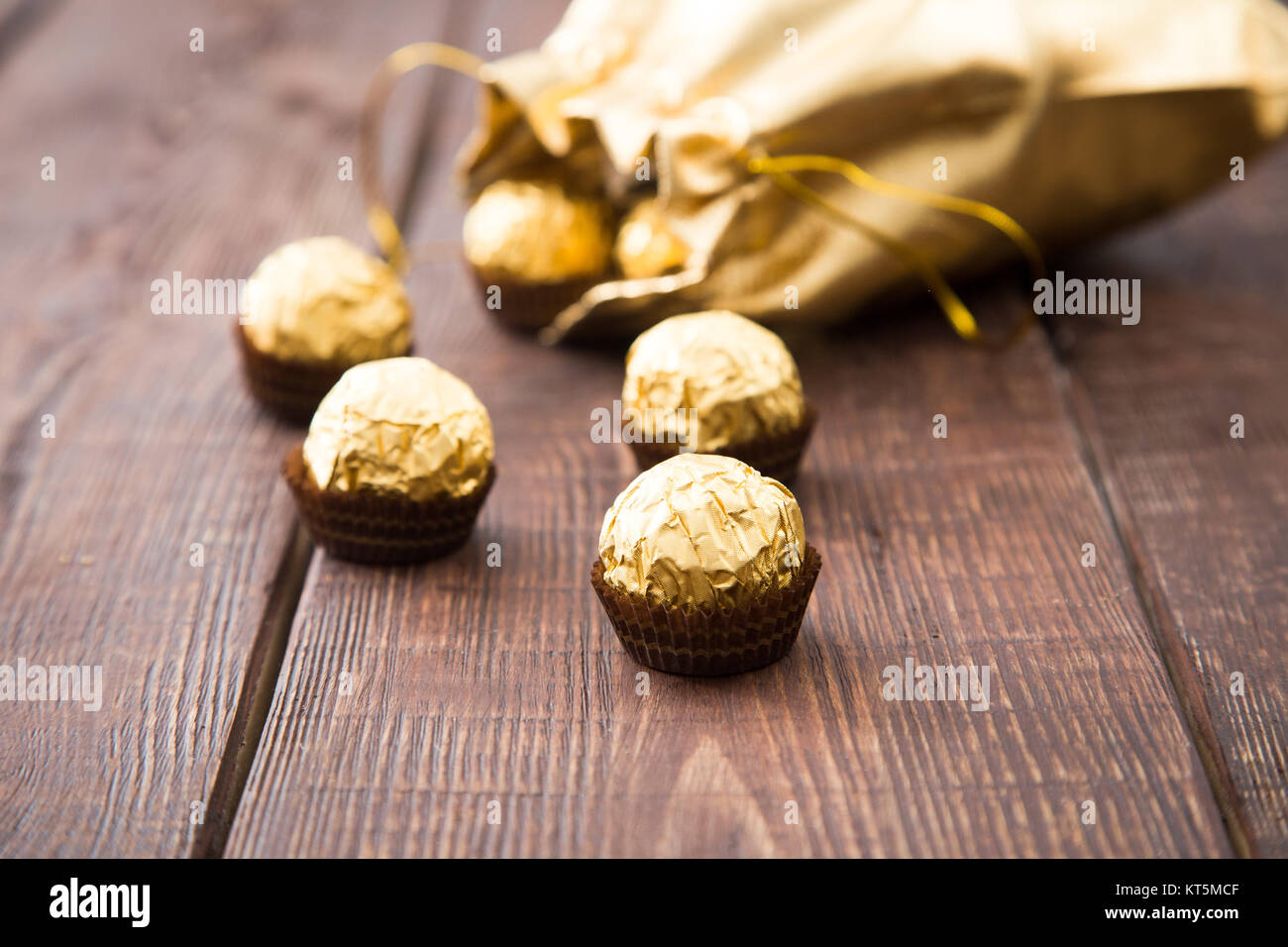 gold bag of chocolates. candy in Golden foil with copy space Stock ...