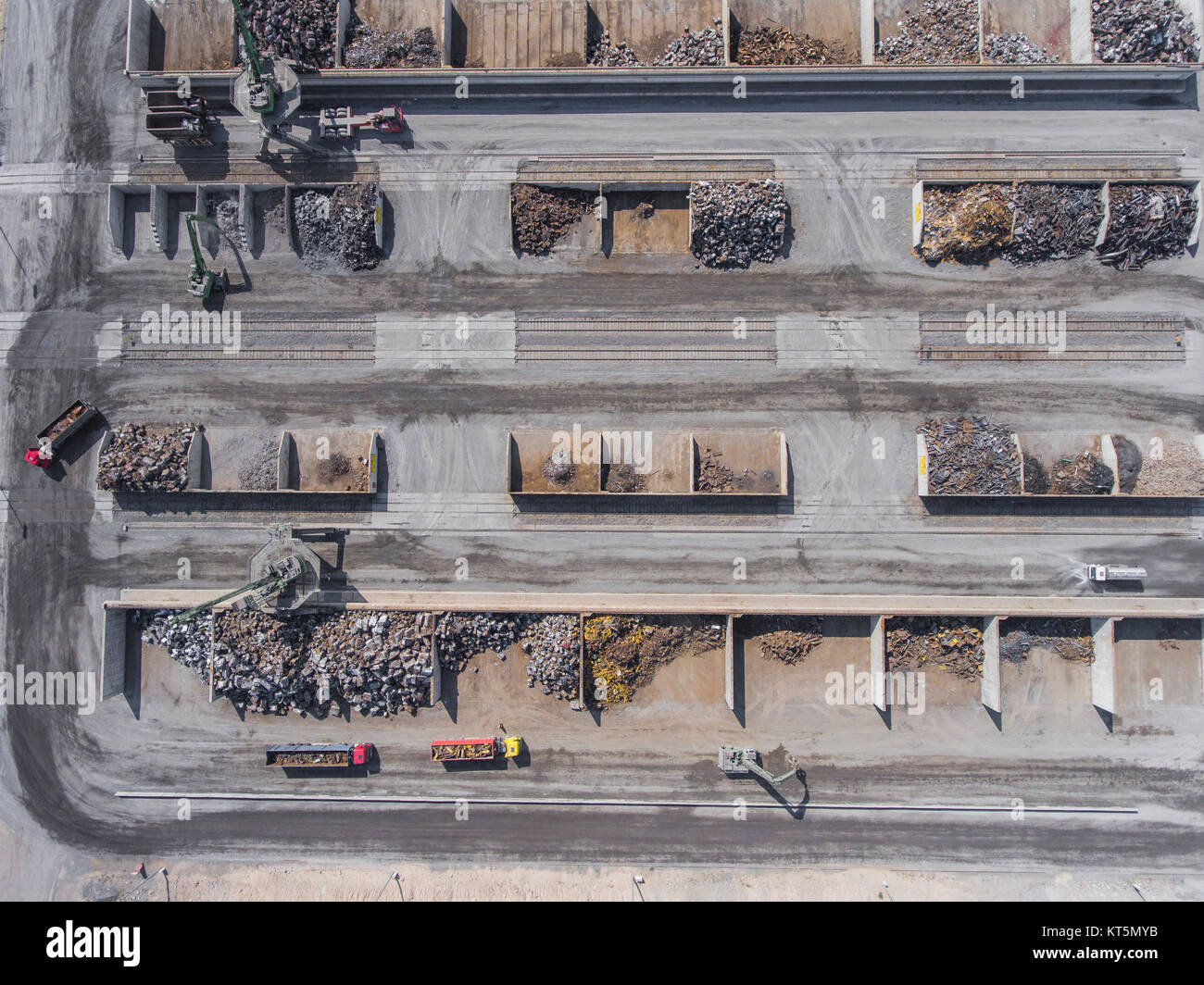 Iron raw materials recycling pile, work machines. Metal waste junkyard ...