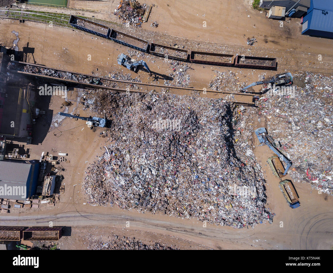 Iron raw materials recycling pile, work machines. Metal waste junkyard ...
