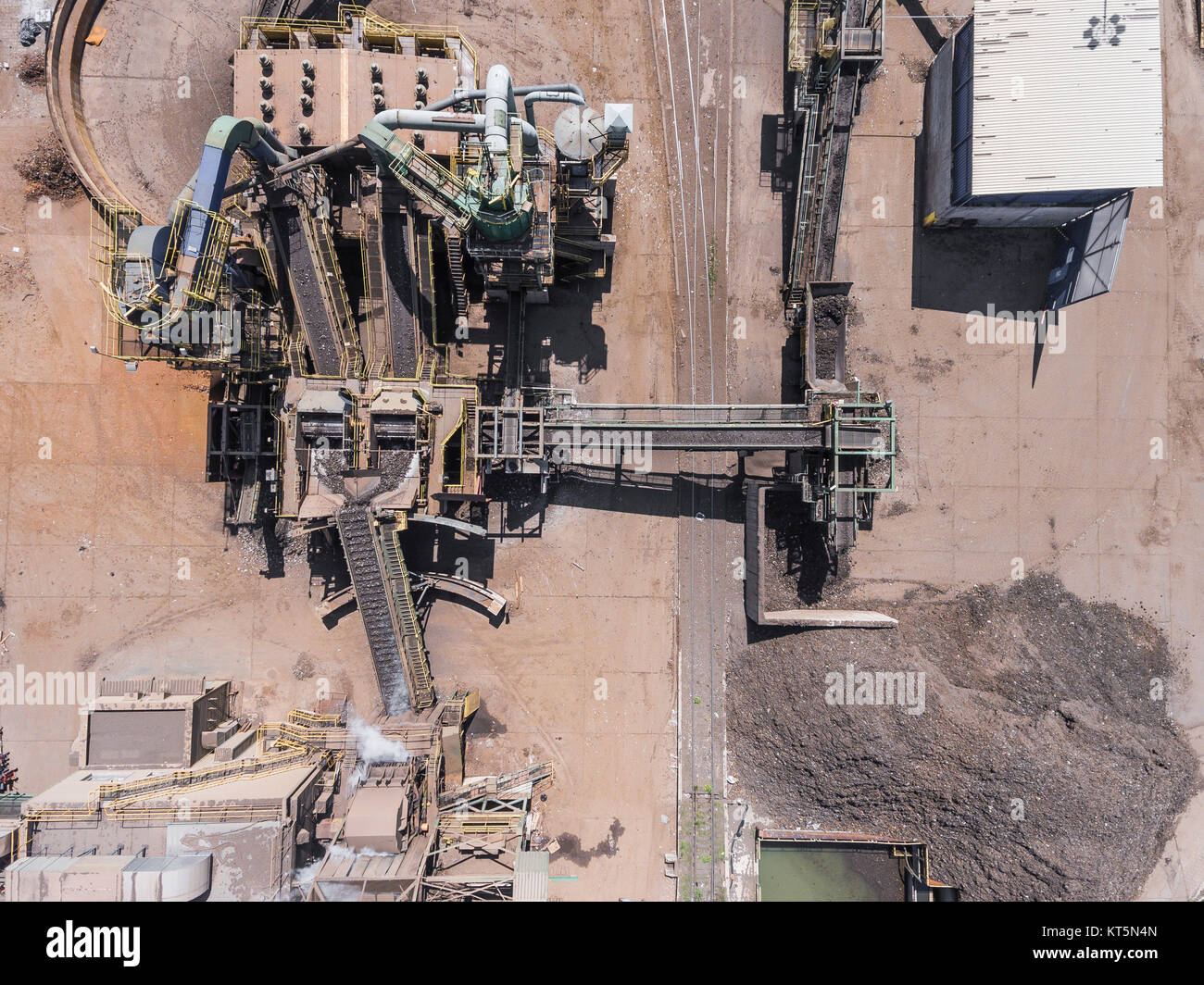 Iron raw materials recycling pile, work machines. Metal waste junkyard ...