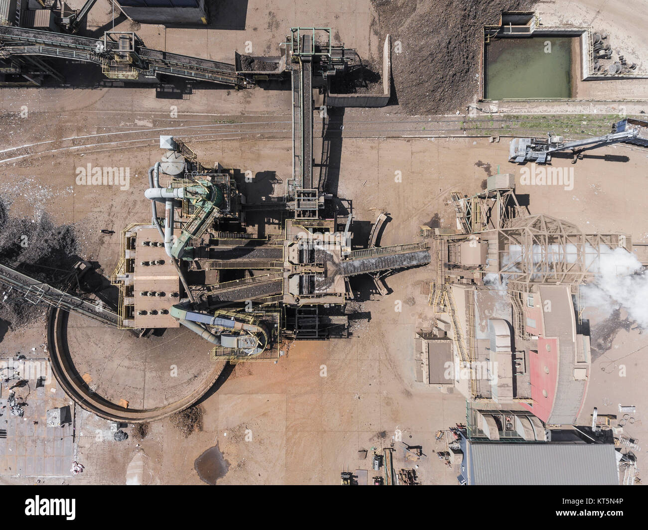 Iron raw materials recycling pile, work machines. Metal waste junkyard ...