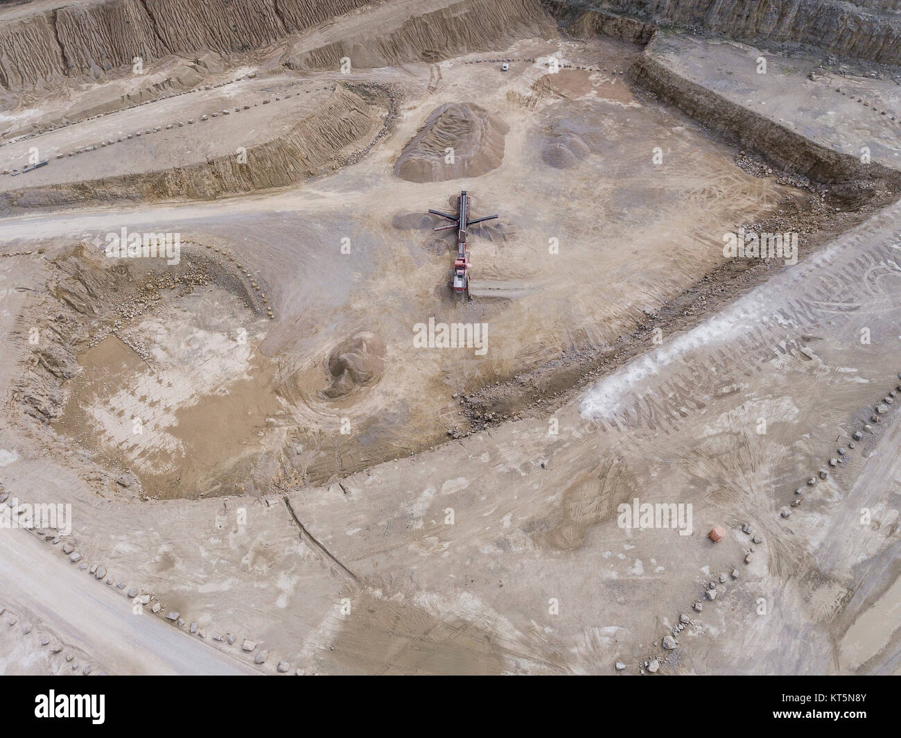 Aerial view of excavator and truck working on the field of sand mine in ...