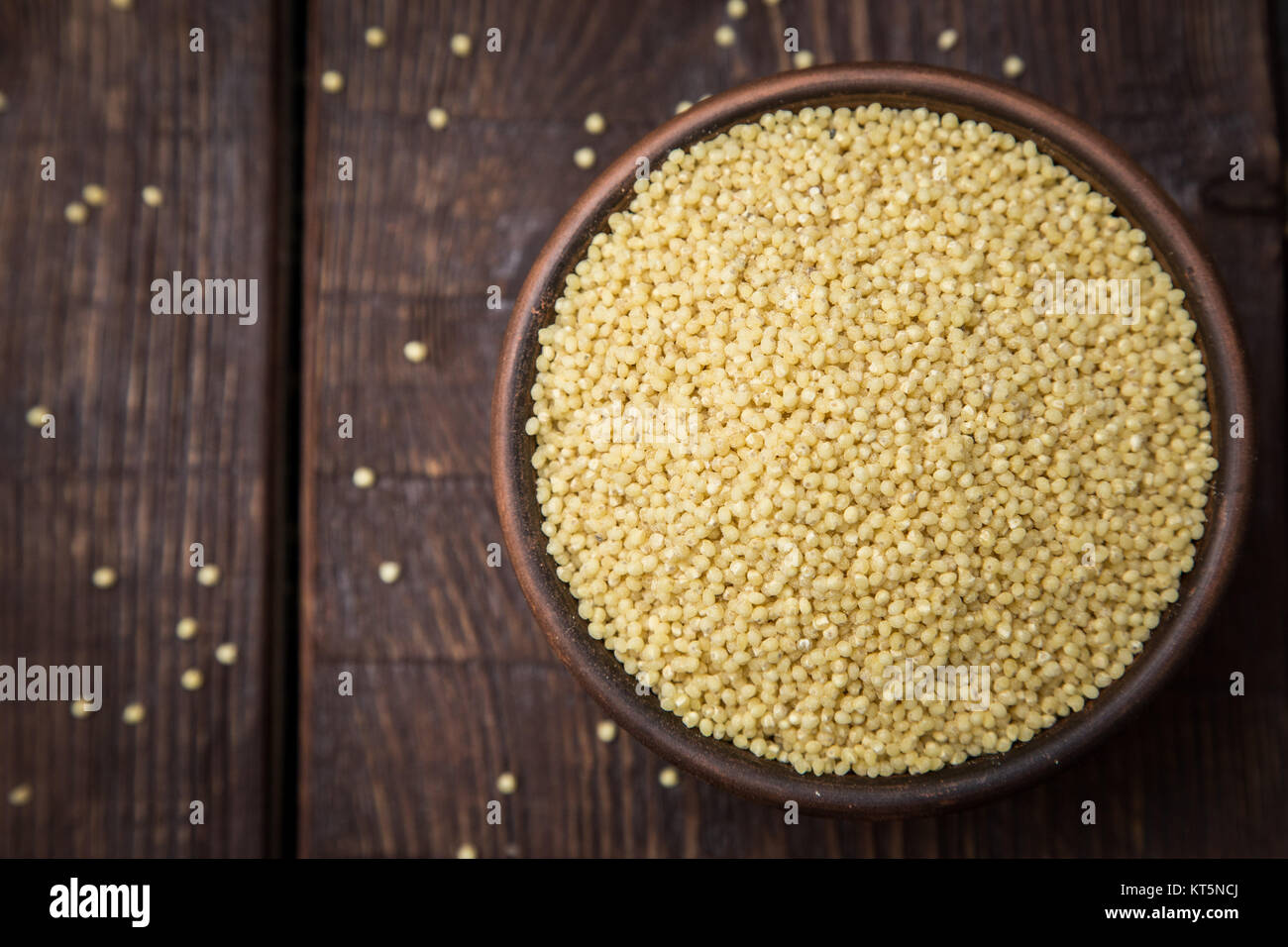 hulled millet on a dark background Stock Photo - Alamy