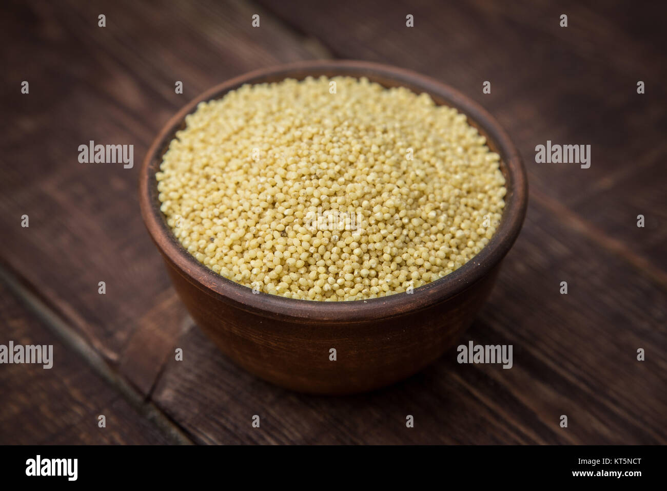 hulled millet on a dark background Stock Photo - Alamy