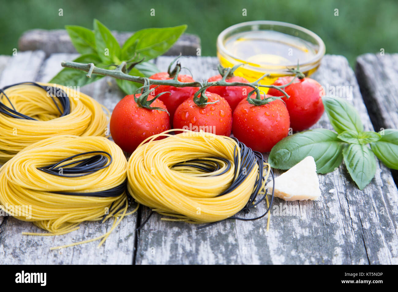 Italian food background with tomatoes, basil, spaghetti, parmesan ...