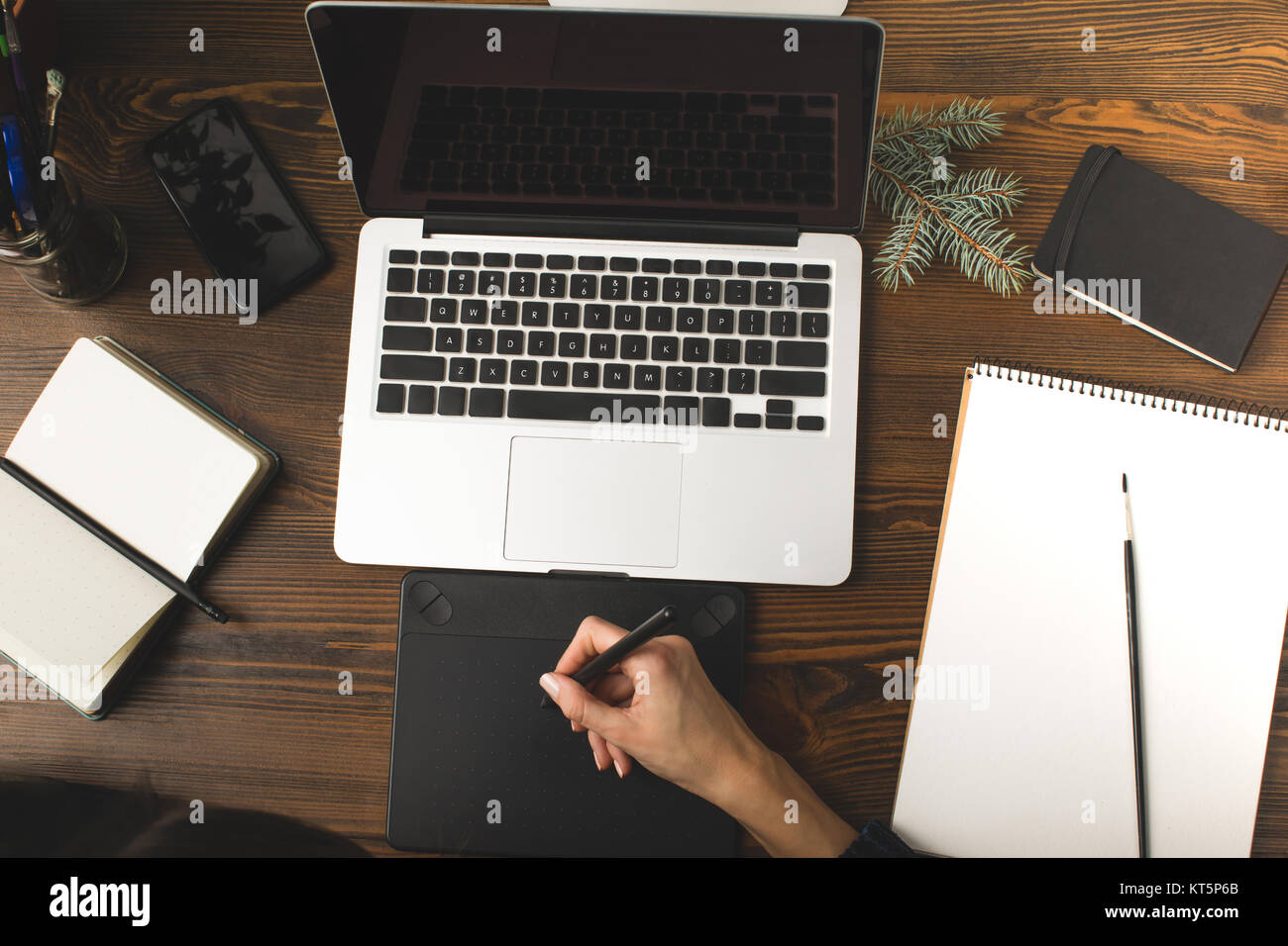 cropped shot of designer using graphics tablet and working with laptop ...