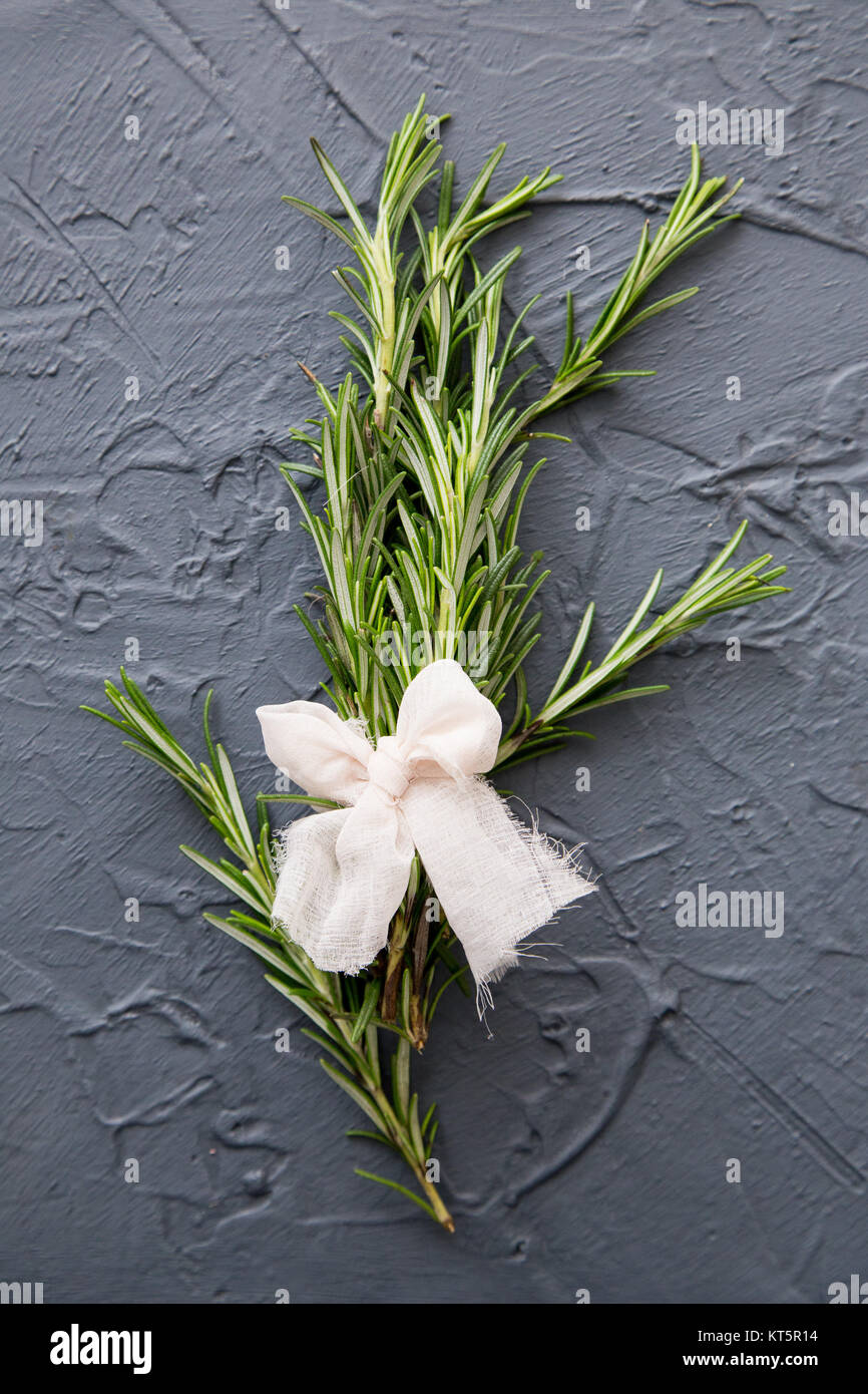 Sprigs of rosemary tied with string on a dark gray background Stock ...