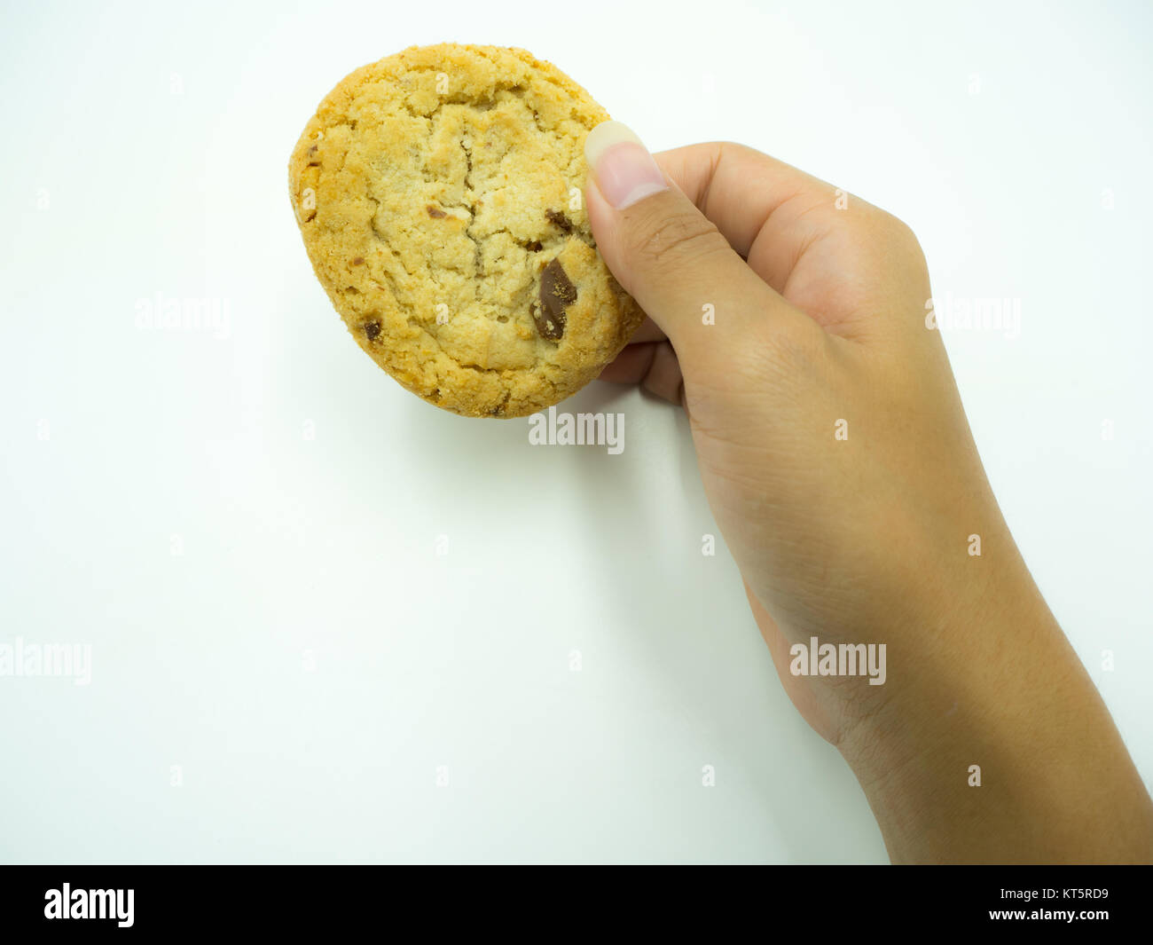 Woman's hand holding chocolate chip cookies Stock Photo - Alamy