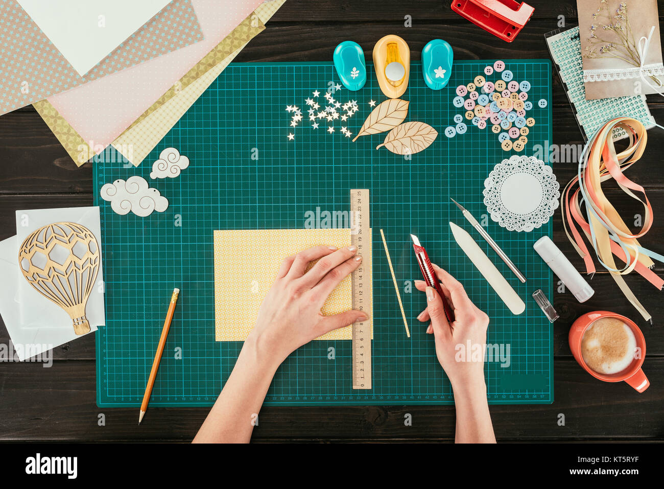 cropped image of woman cutting paper with stationery knife Stock Photo ...