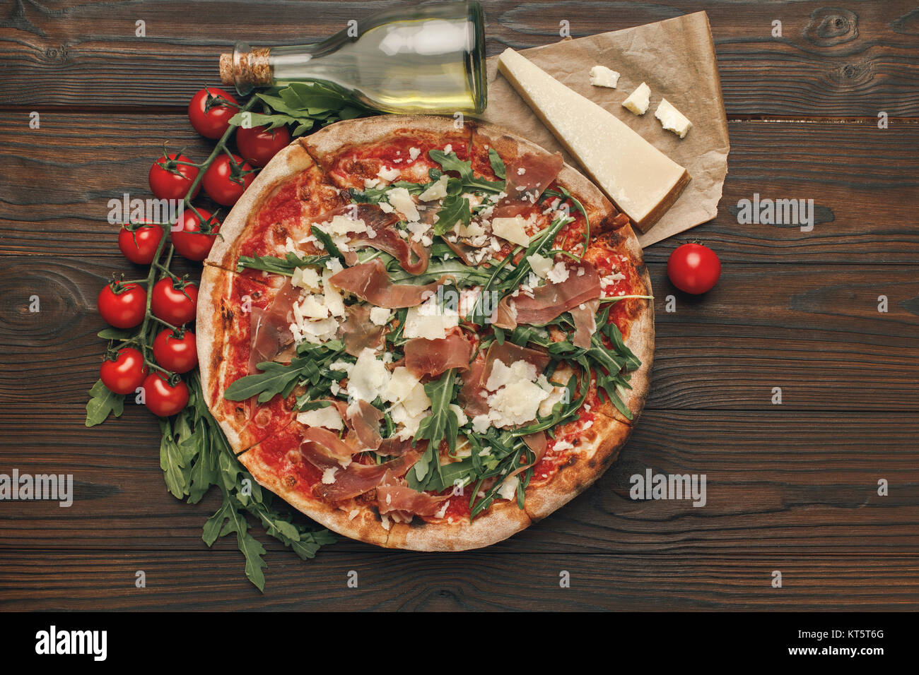 flat lay with italian pizza and various ingredients on wooden tabletop ...