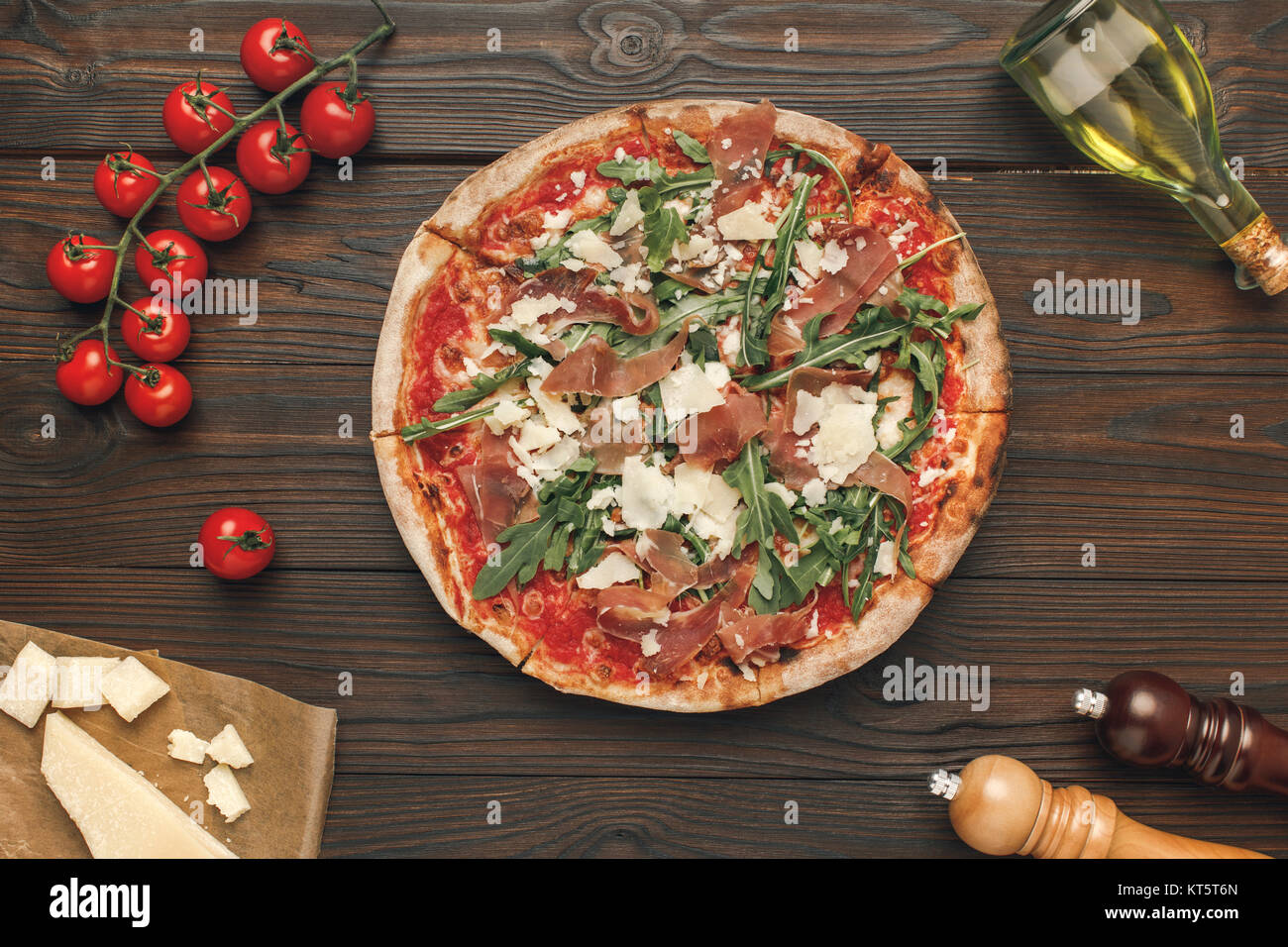 flat lay with homemade italian pizza, olive oil, cherry tomatoes and ...