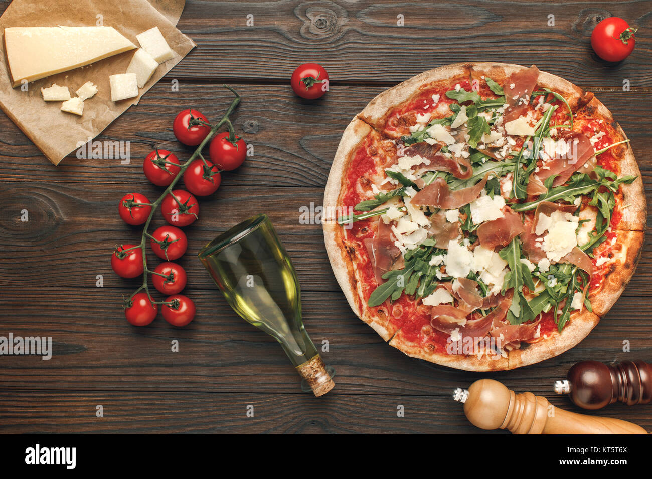 flat lay with homemade italian pizza, olive oil, cherry tomatoes and ...