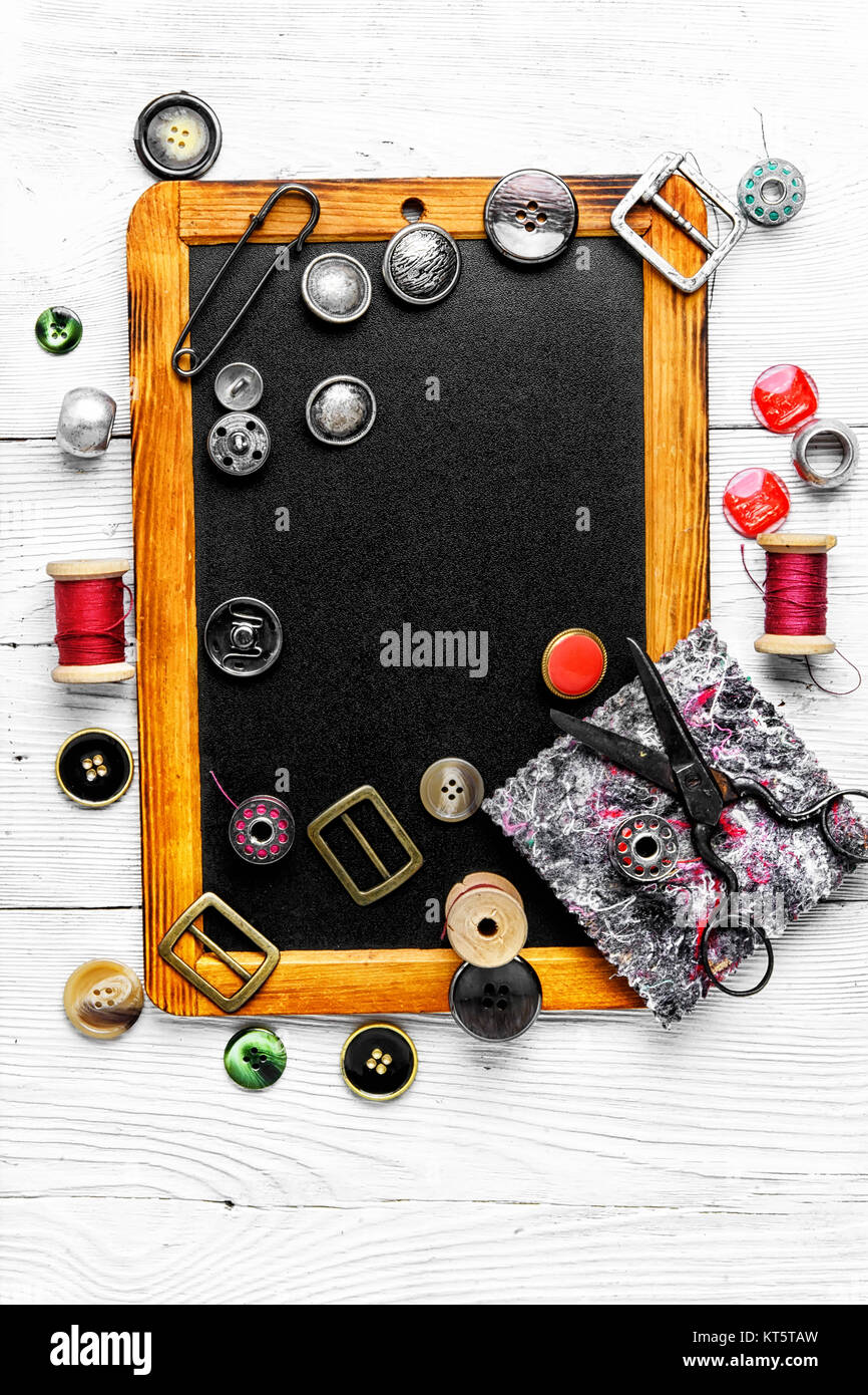 Set of buttons and thread on the chalk board for drawing.Copy space ...