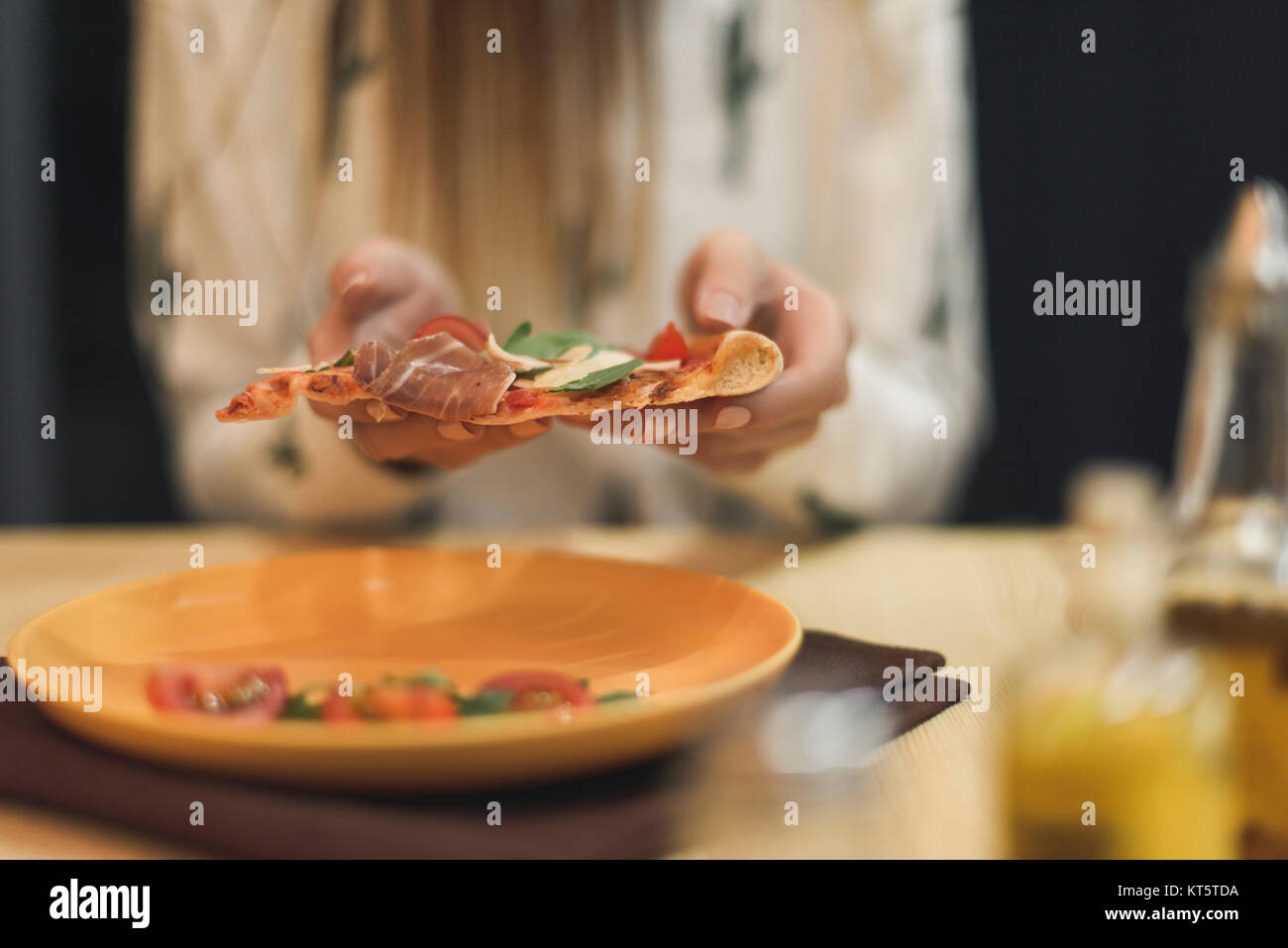 Woman eating pizza alone in restaurant hi-res stock photography and ...