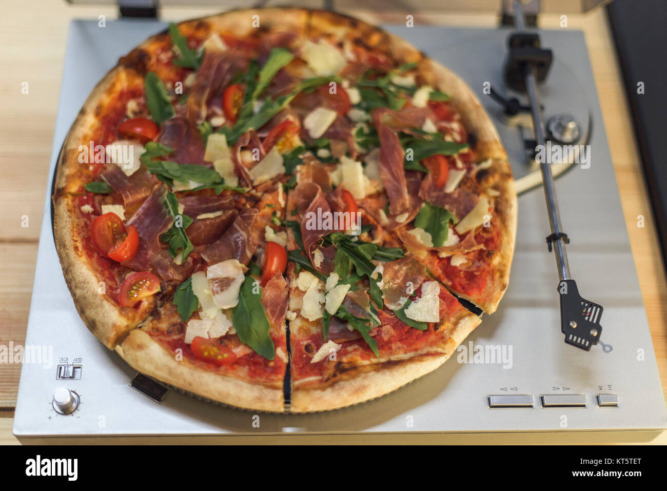 close up view of italian pizza on retro vinyl record player Stock Photo ...