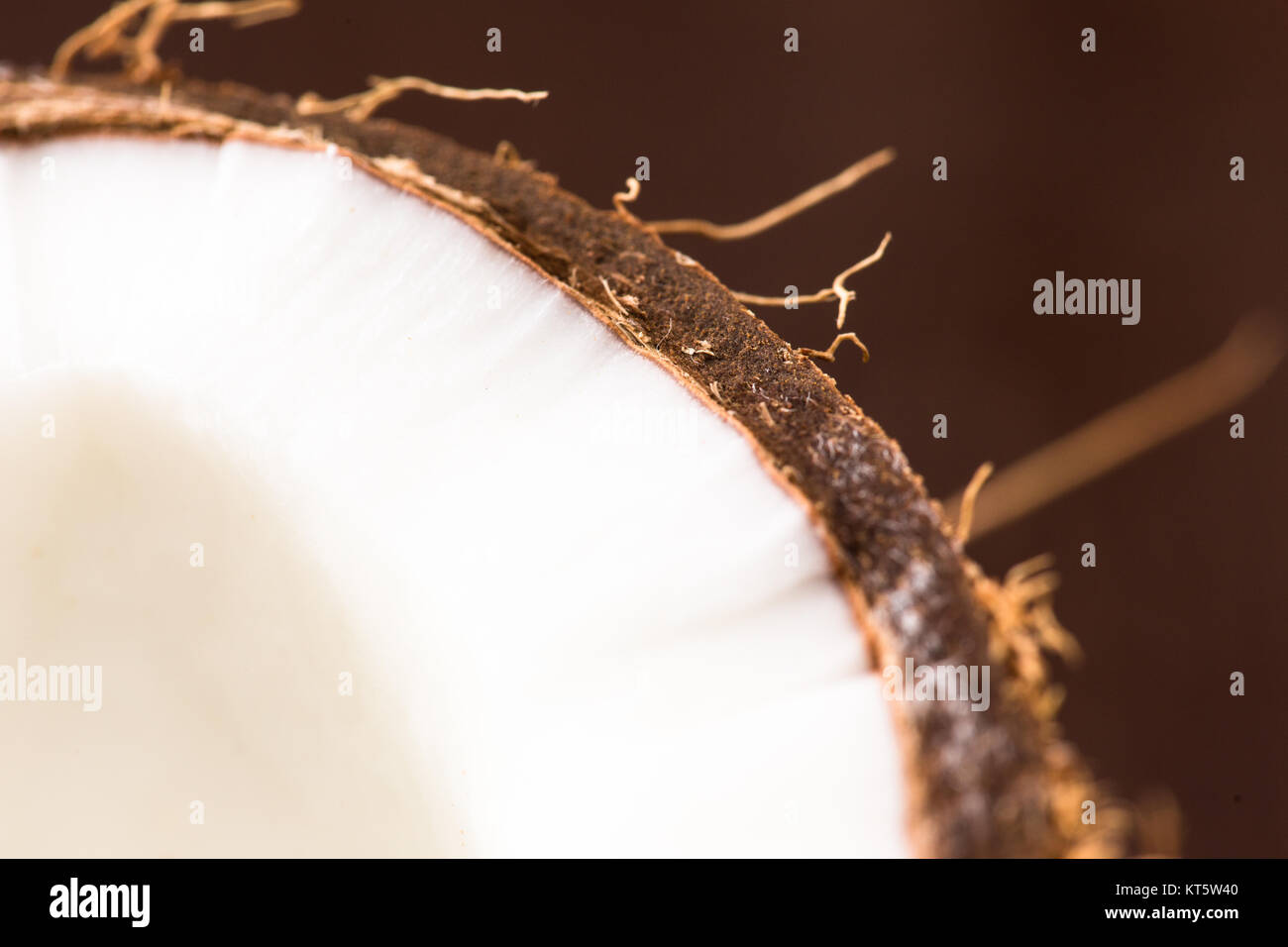 Half of ripe coconut on wooden background Stock Photo - Alamy