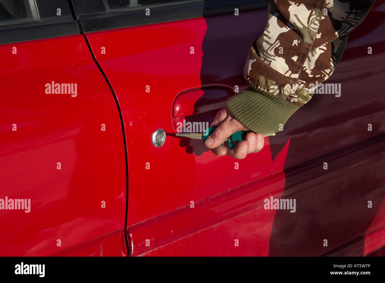 closing lock the car with the key. men's hand puts the key into the ...