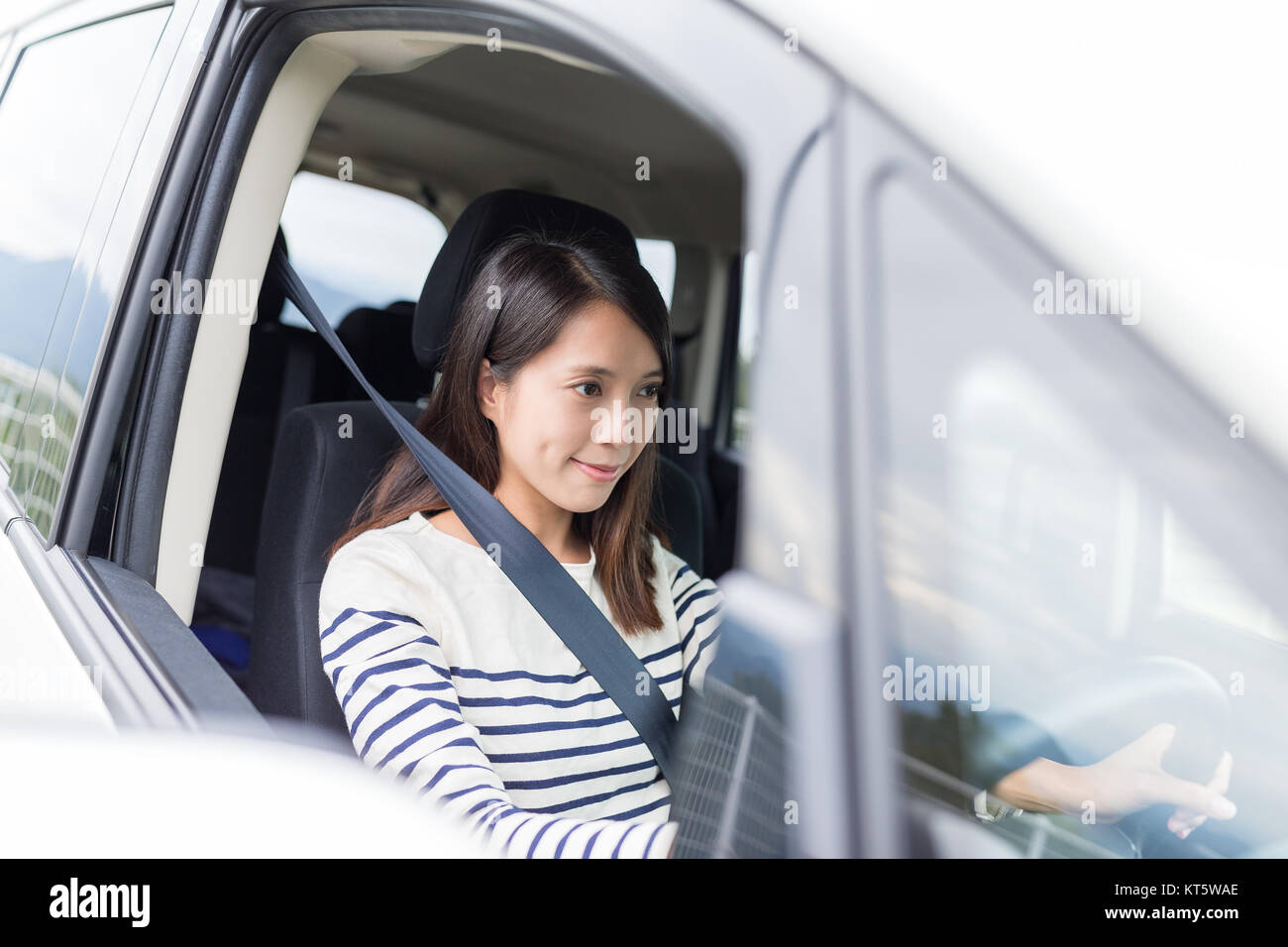 Young woman driving her car Stock Photo - Alamy