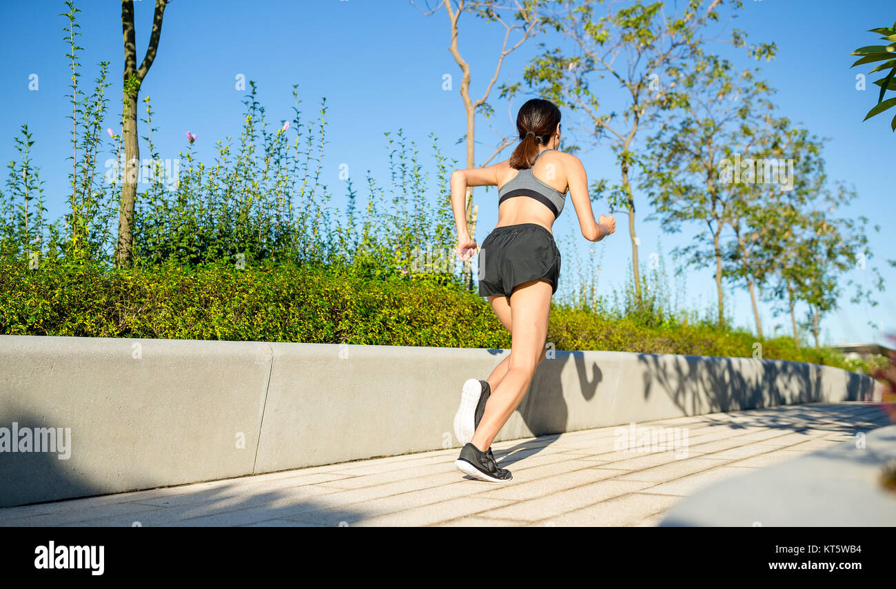 Woman running at park Stock Photo - Alamy