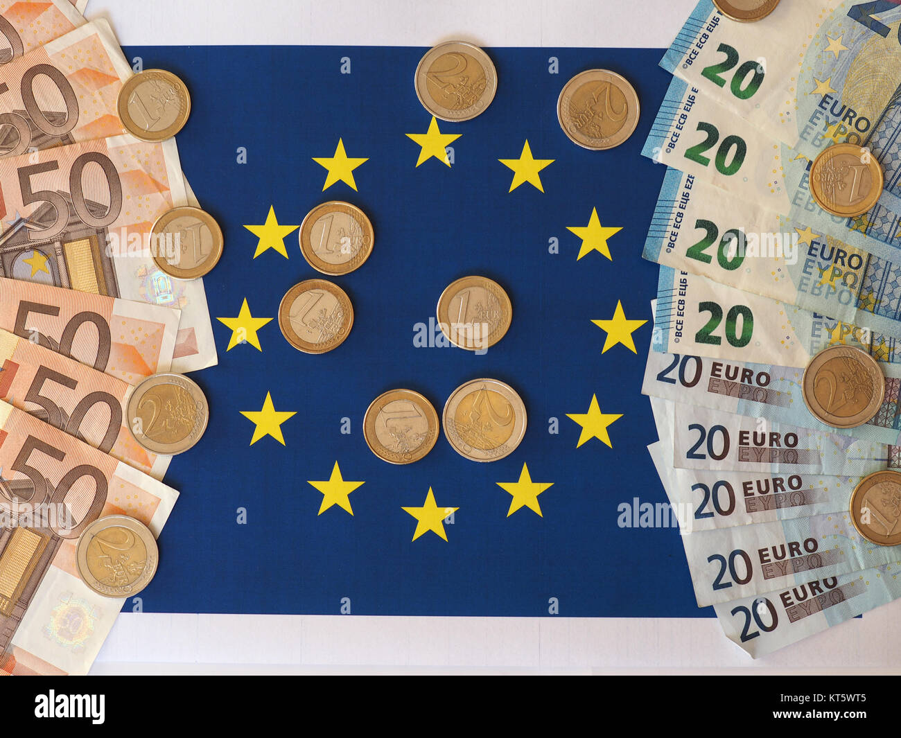 Euro notes and coins, European Union, over flag Stock Photo - Alamy