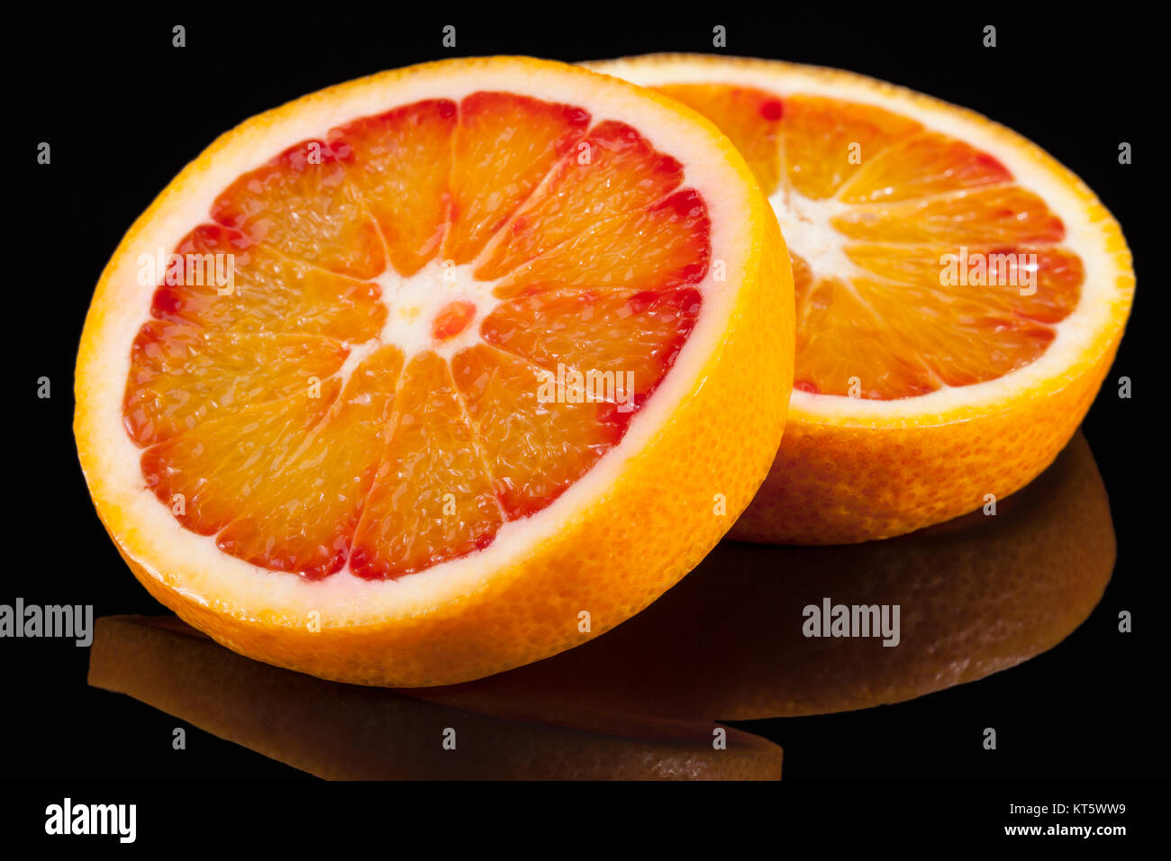 Slices of red orange isolated on black background Stock Photo - Alamy