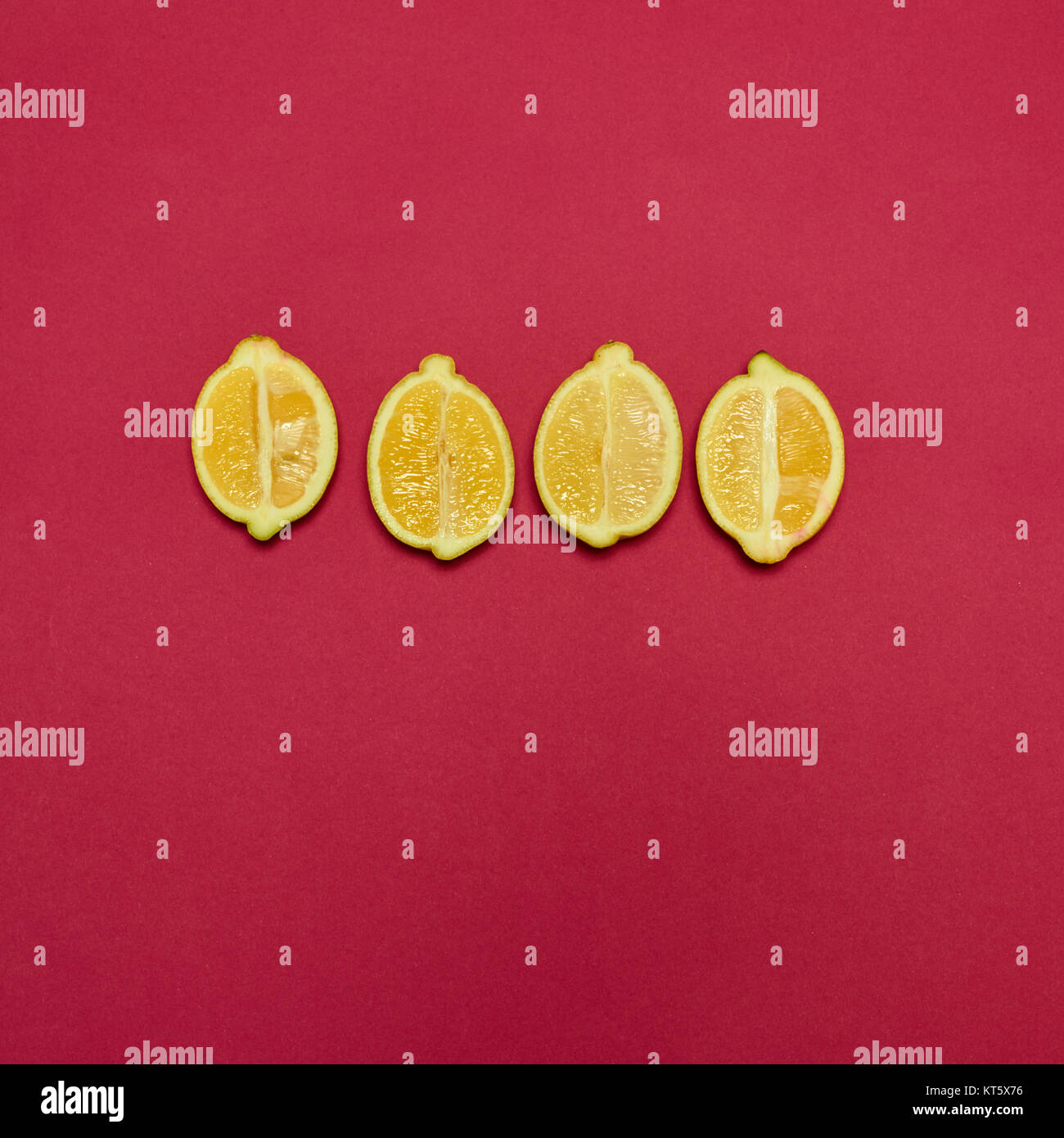 Lemons on red background Stock Photo - Alamy
